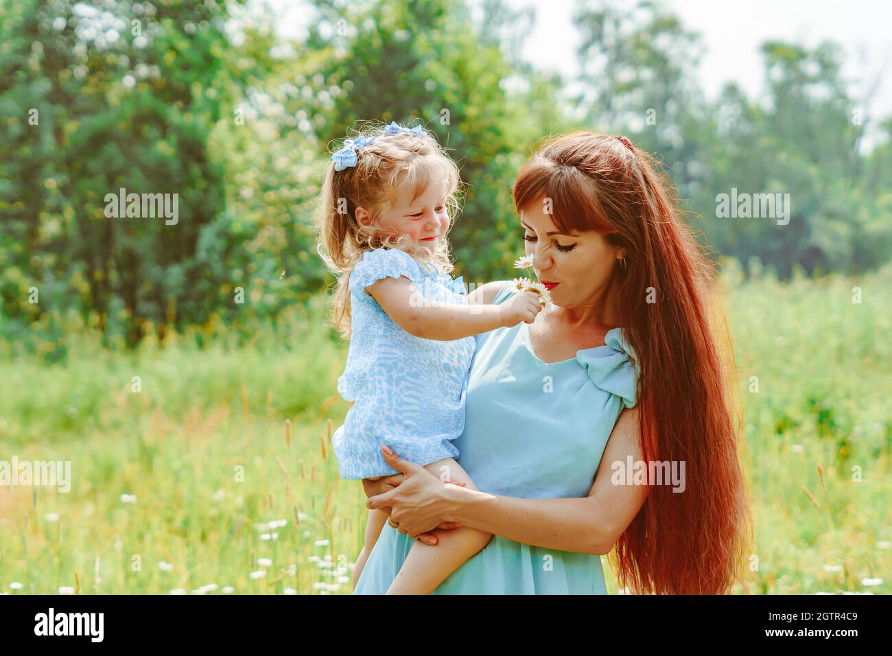 mom hugs her daughter in nature Stock Photo - Alamy