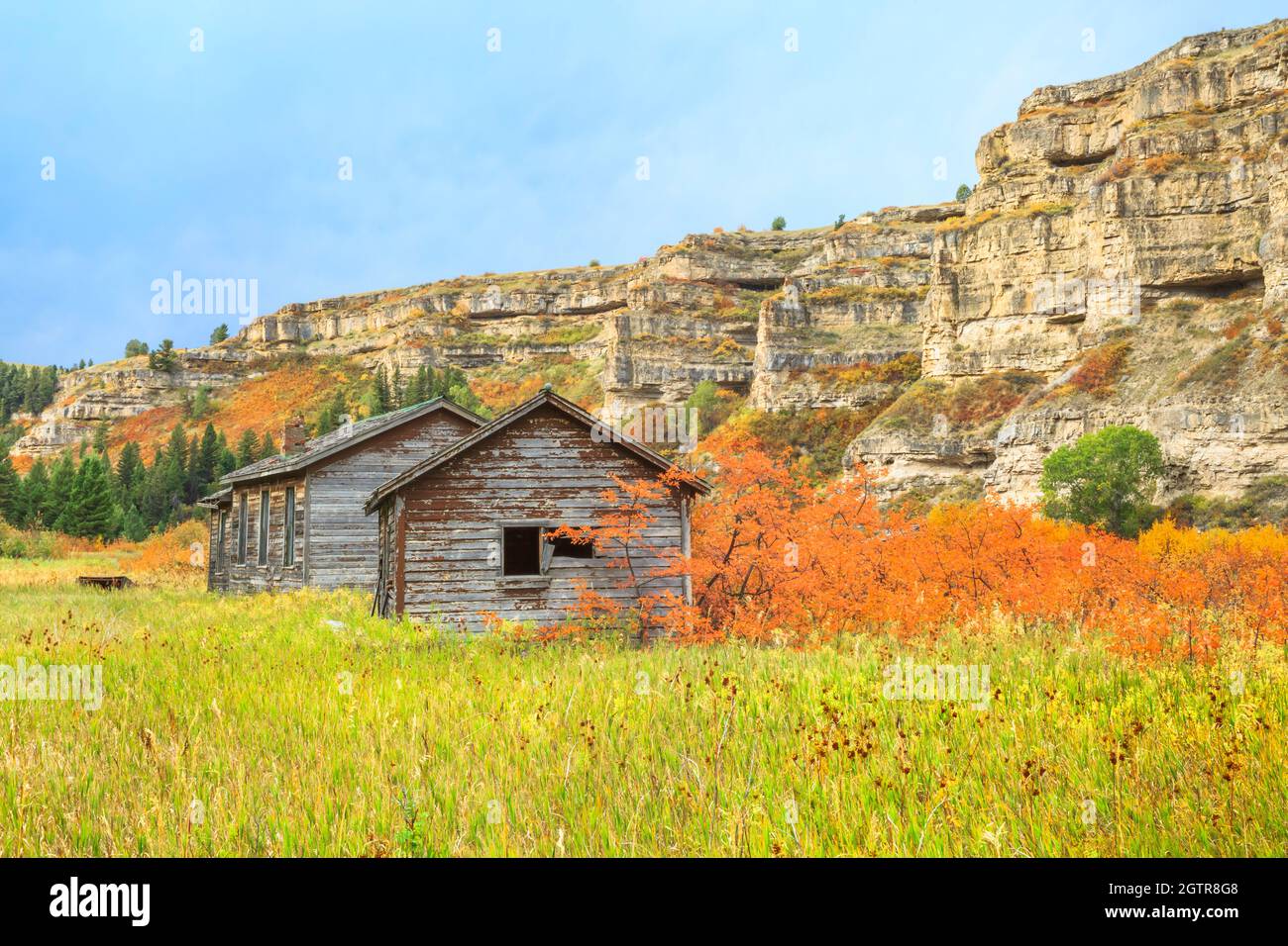 old cabins below limestone cliffs of the belt creek valley in sluice ...