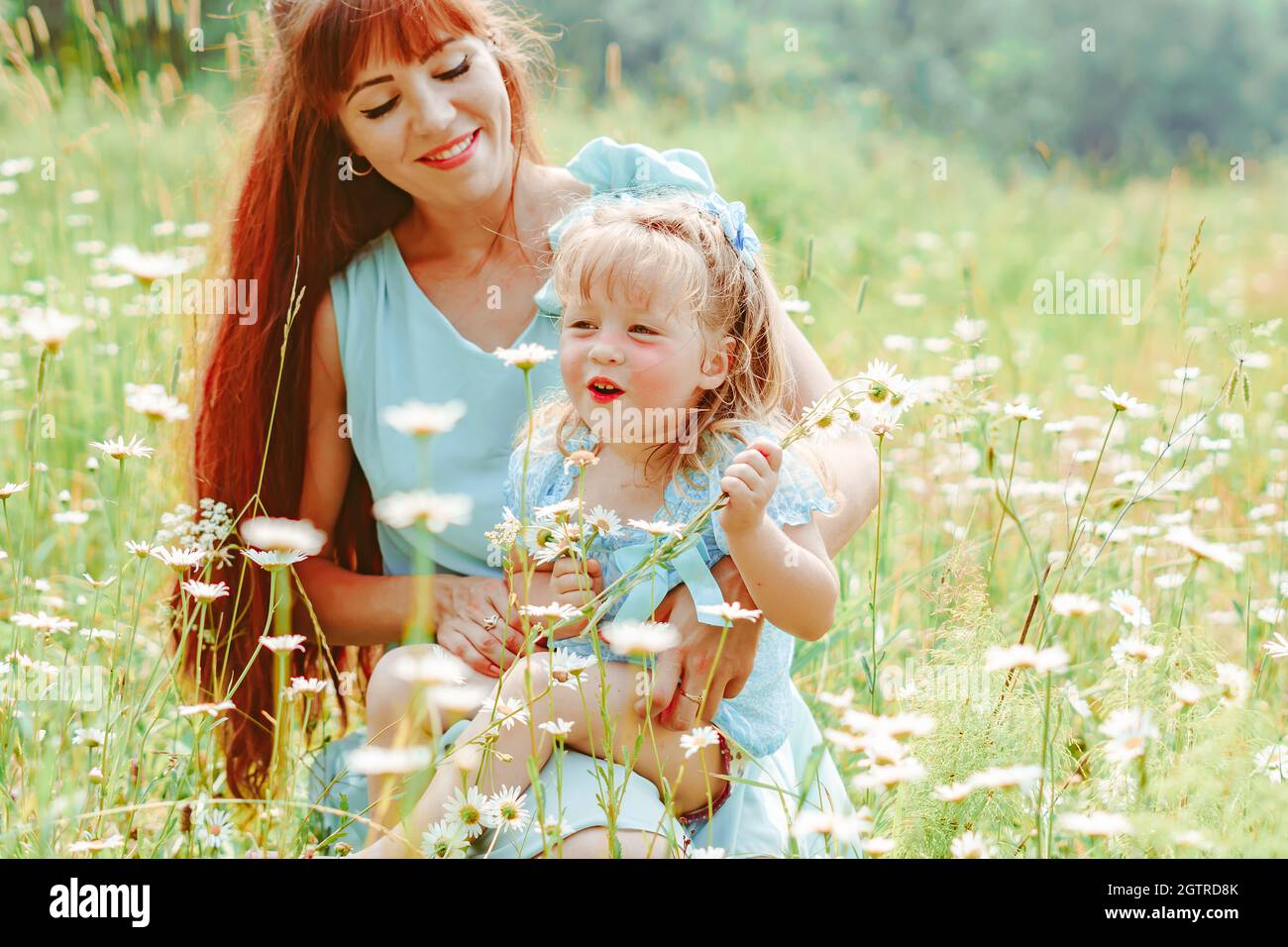 mom hugs her daughter in nature Stock Photo - Alamy