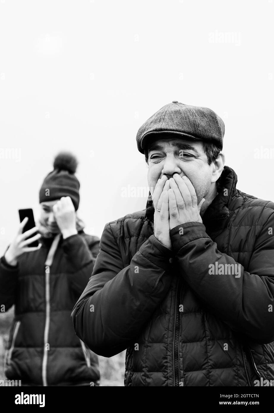Angry Father Standing With Daughter Using Phone In Background Stock ...