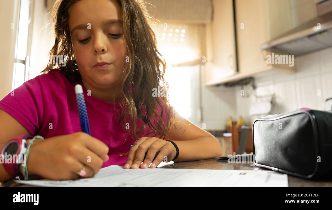 girl writing on a piece of paper Stock Photo - Alamy