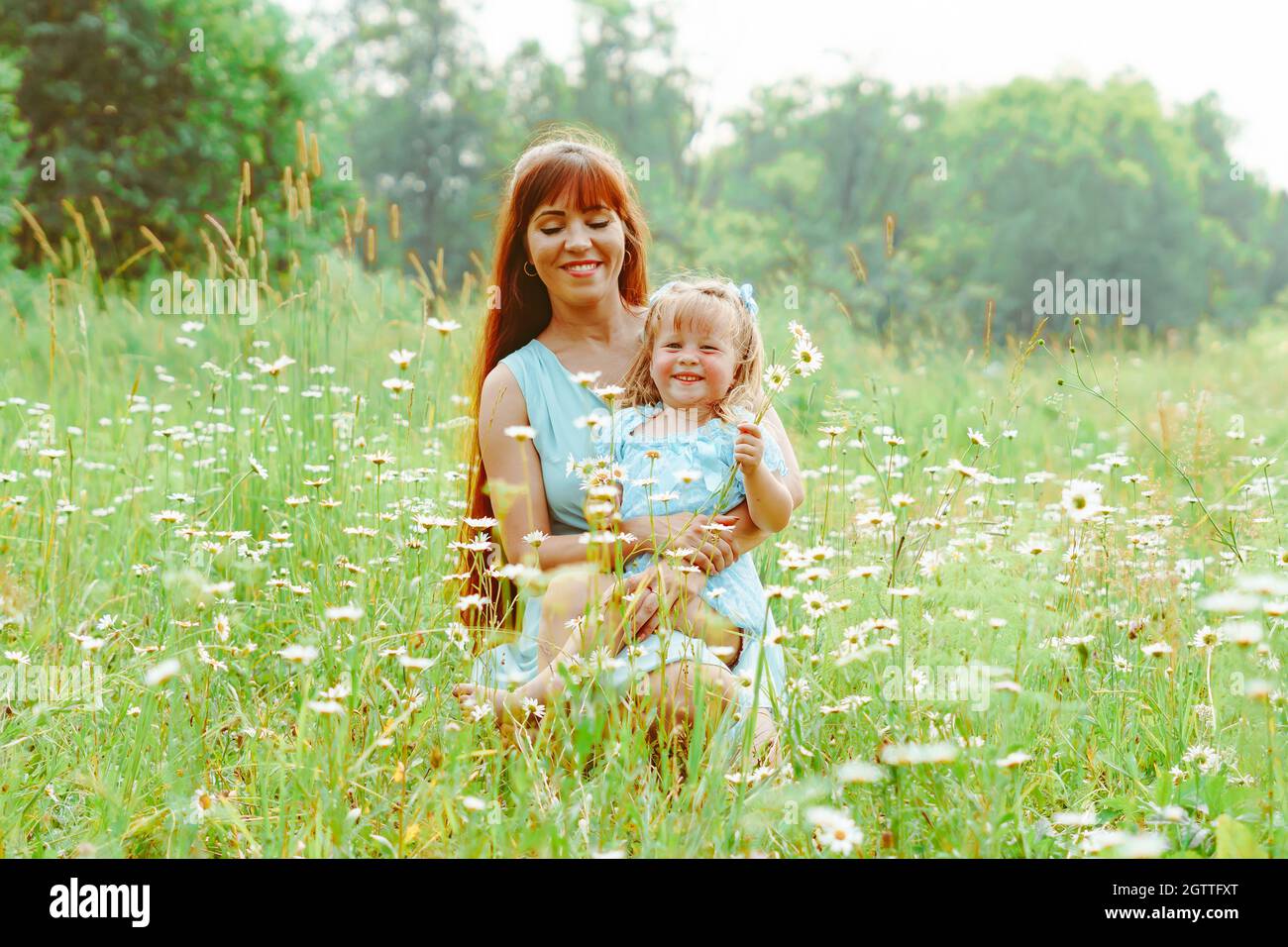 mom hugs her daughter in nature Stock Photo - Alamy