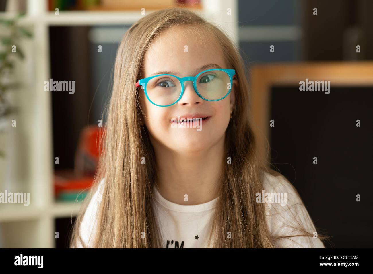 Beautiful portrait of a girl with Down syndrome at school Stock Photo ...