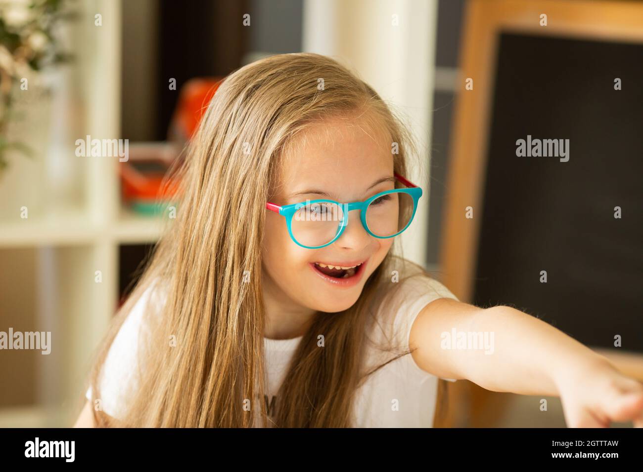 A girl with Down syndrome experiences positive emotions and joy Stock ...