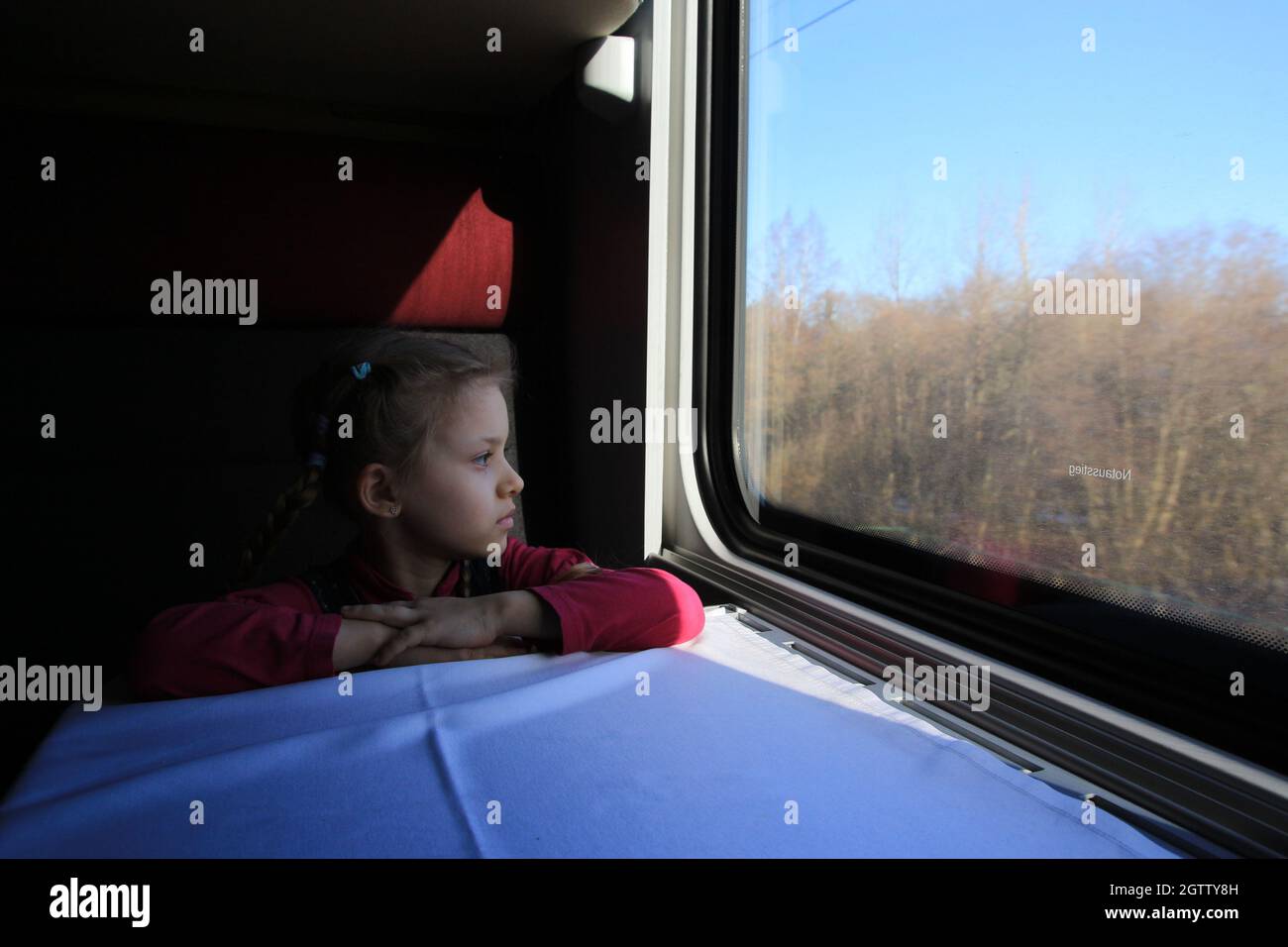 Girls looking through window train hi-res stock photography and images ...