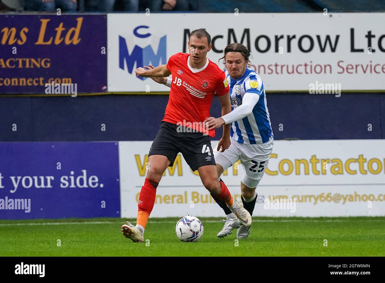 Luton, UK. 02nd Oct, 2021. Kal Naismith #4 of Luton Town battles with ...