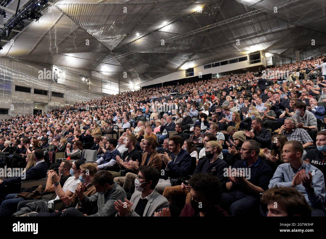 The audience of around 1,500 people are seen on the stands applauding ...