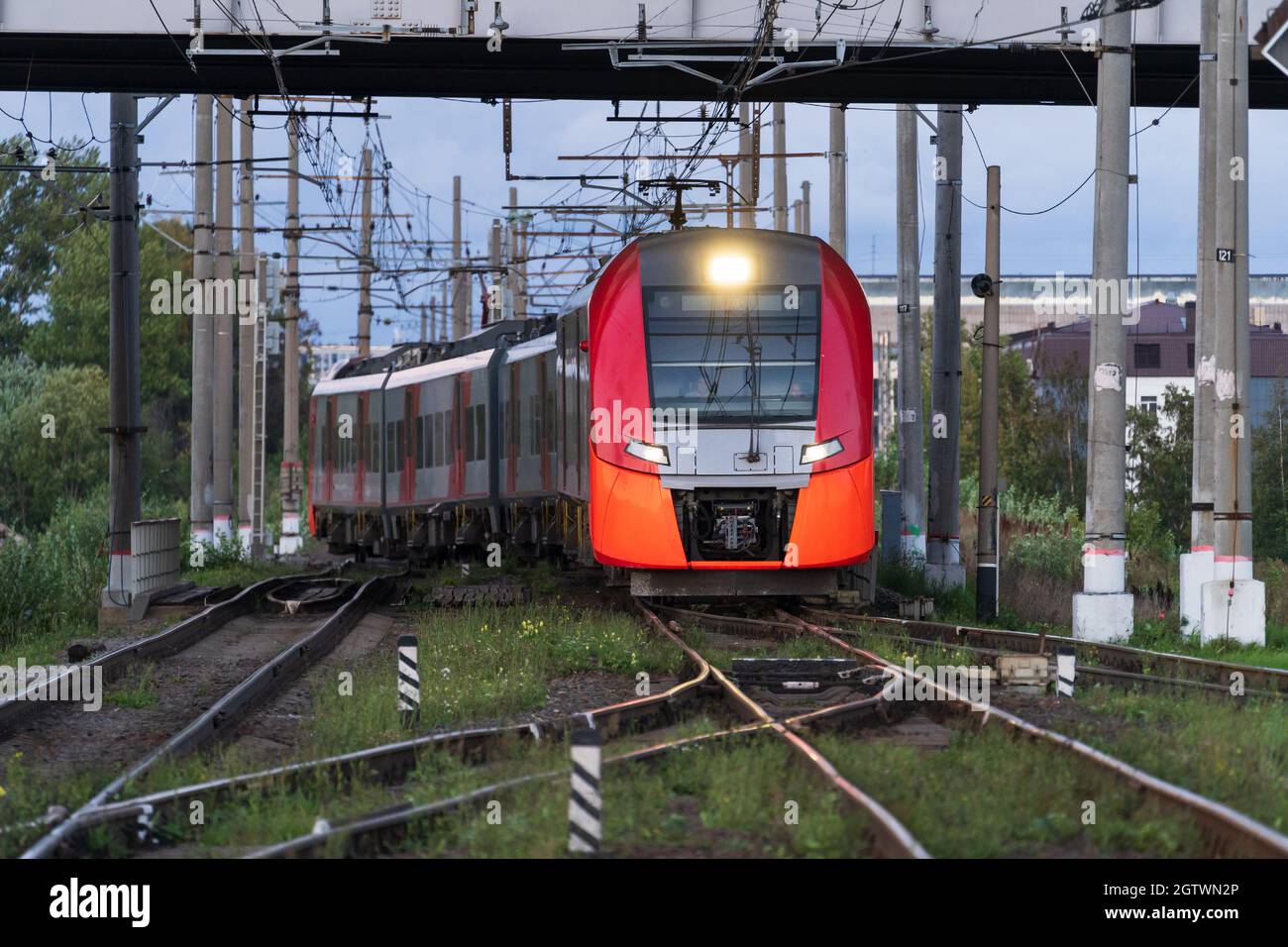 Modern intercity high speed train under the bridge at sunset ...