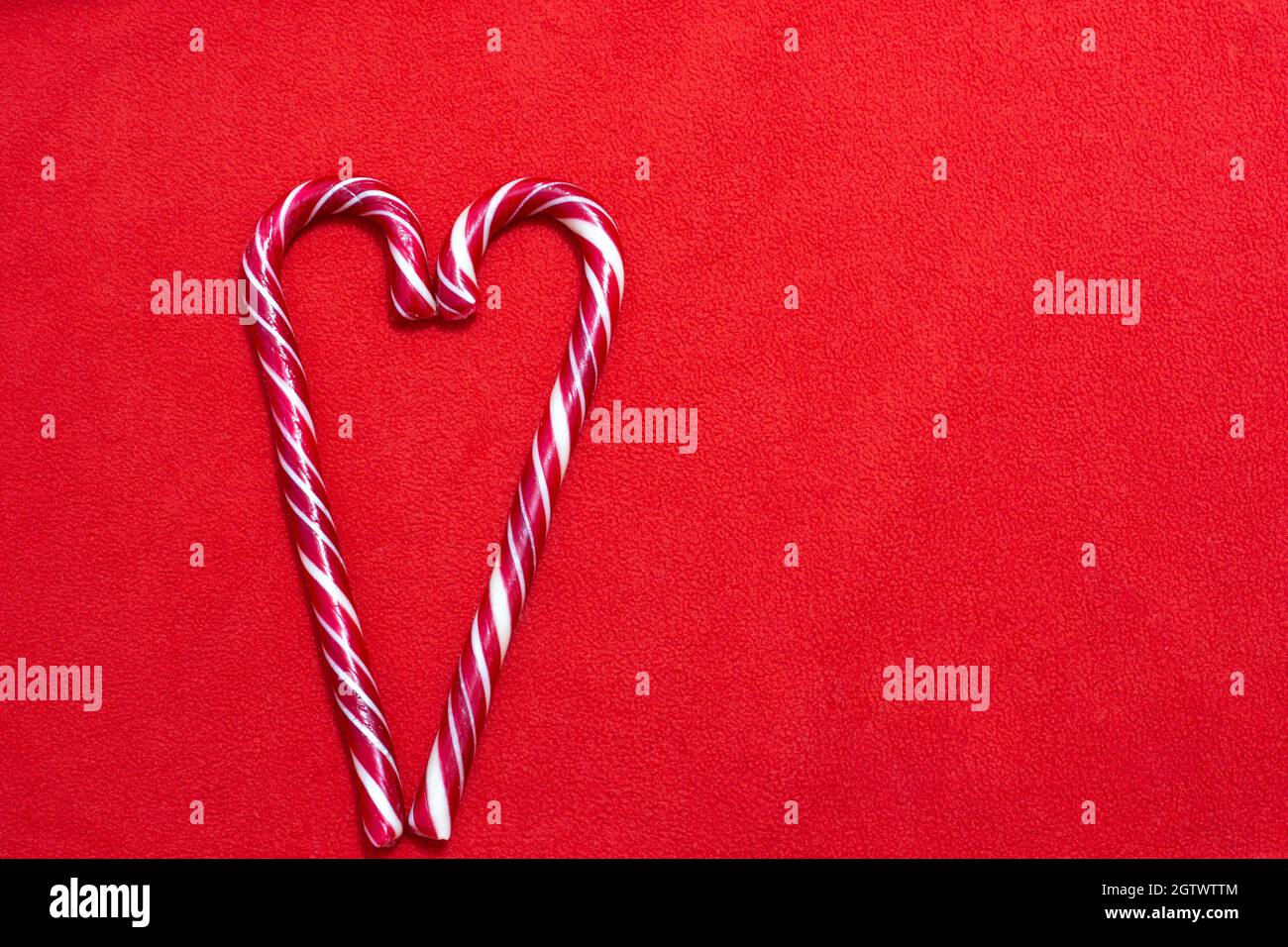 heart-shaped candy cane on red fabric background, with copy space Stock ...