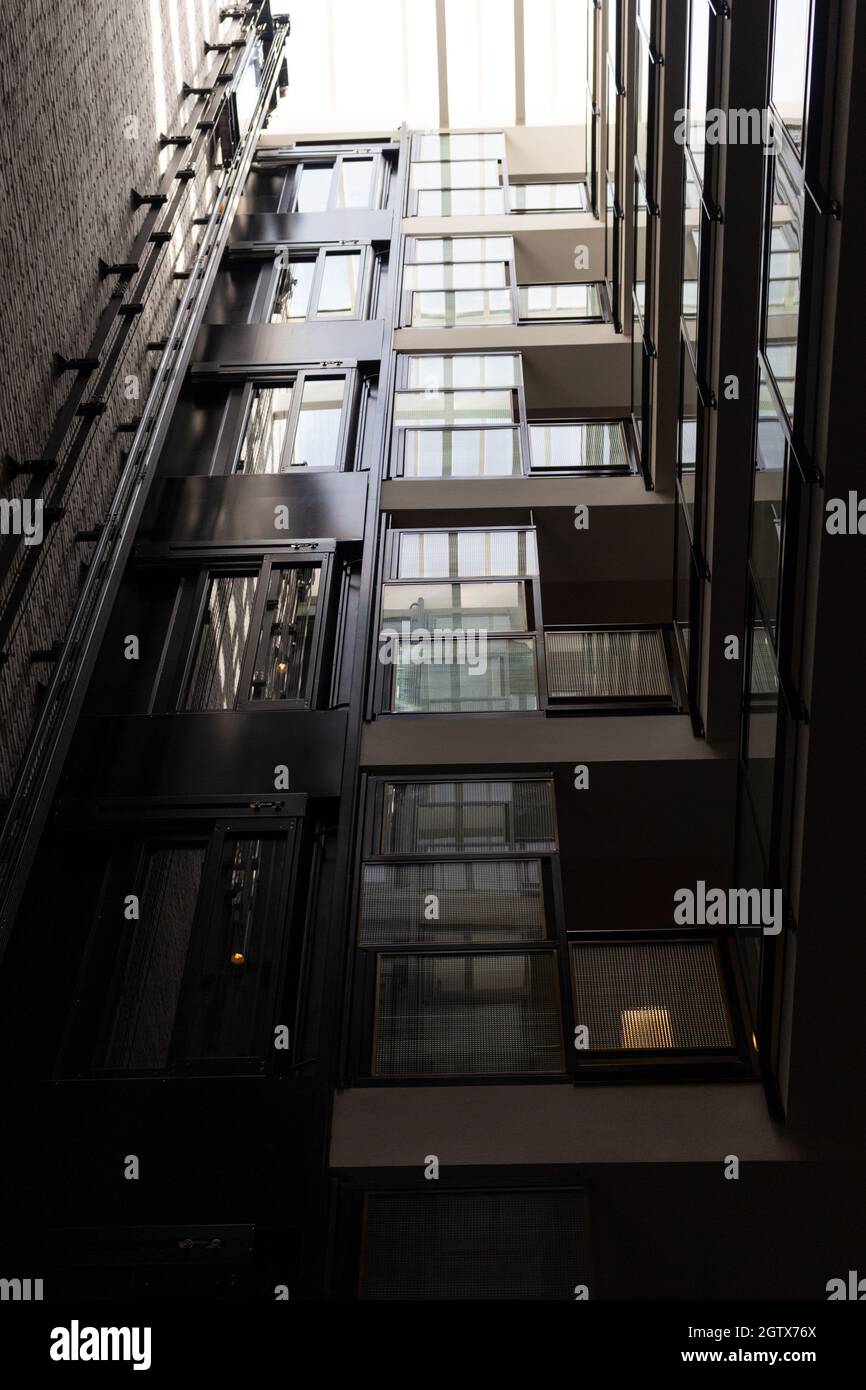 Low angle shot of glass walls of a building as seen from an atrium ...