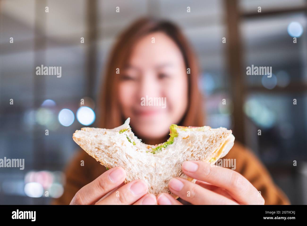 Indian woman eating sandwich hi-res stock photography and images - Alamy