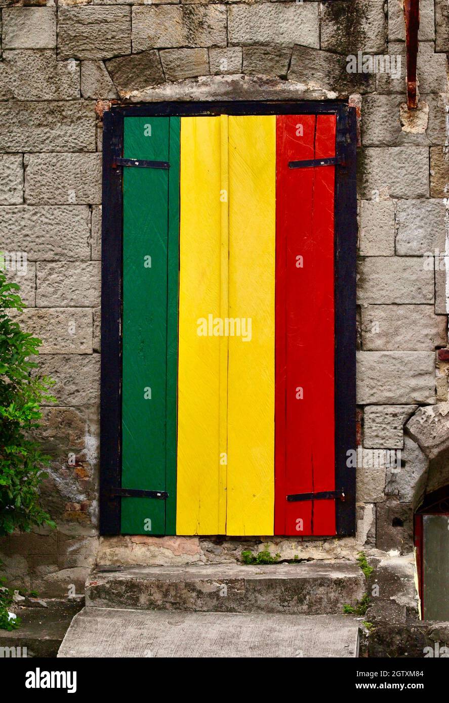 The colors of the Rastafarian/Reggae flag on the door and shutters of a ...
