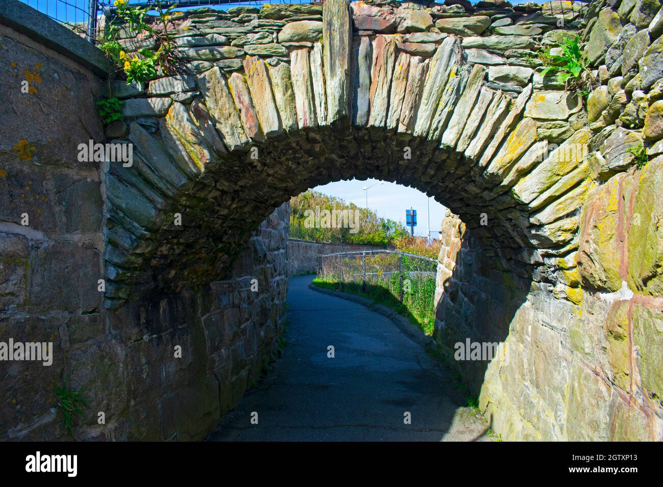 Cute stone bridge over a pedestrian walkway at the cliff walk in ...