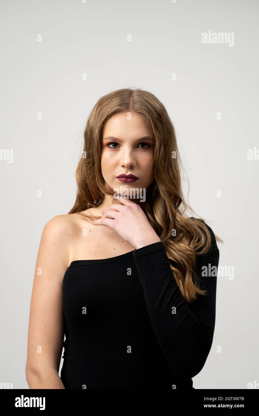 Beautiful young woman portrait in a black t-shirt. Studio shot ...
