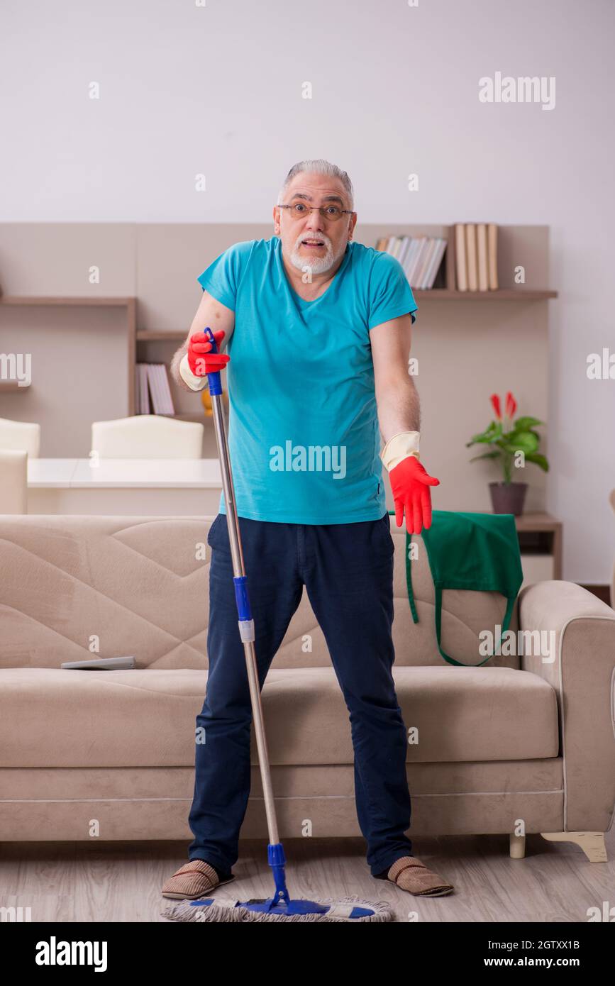Aged man cleaning the house Stock Photo - Alamy