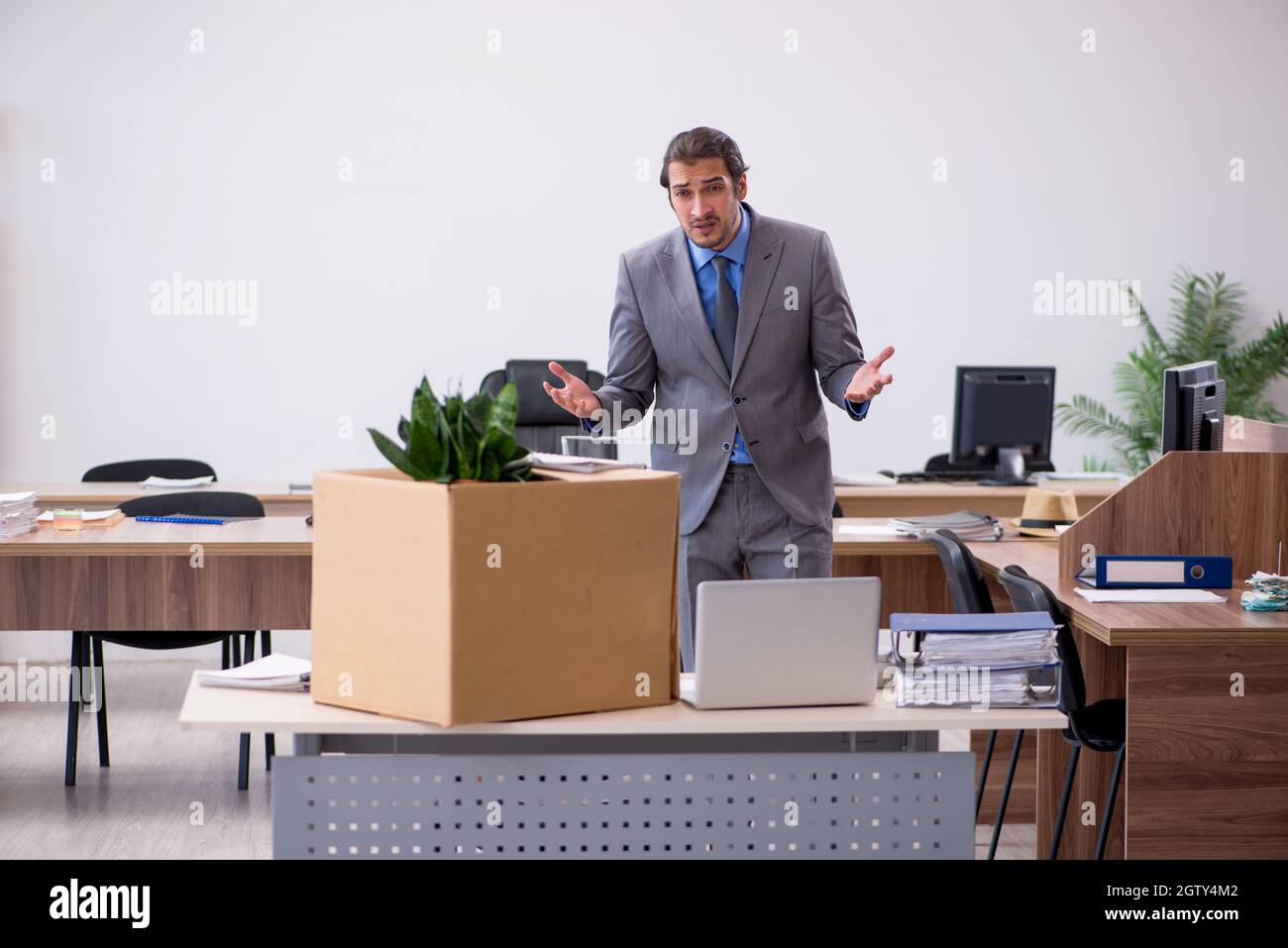 Young employee being fired from his work Stock Photo - Alamy