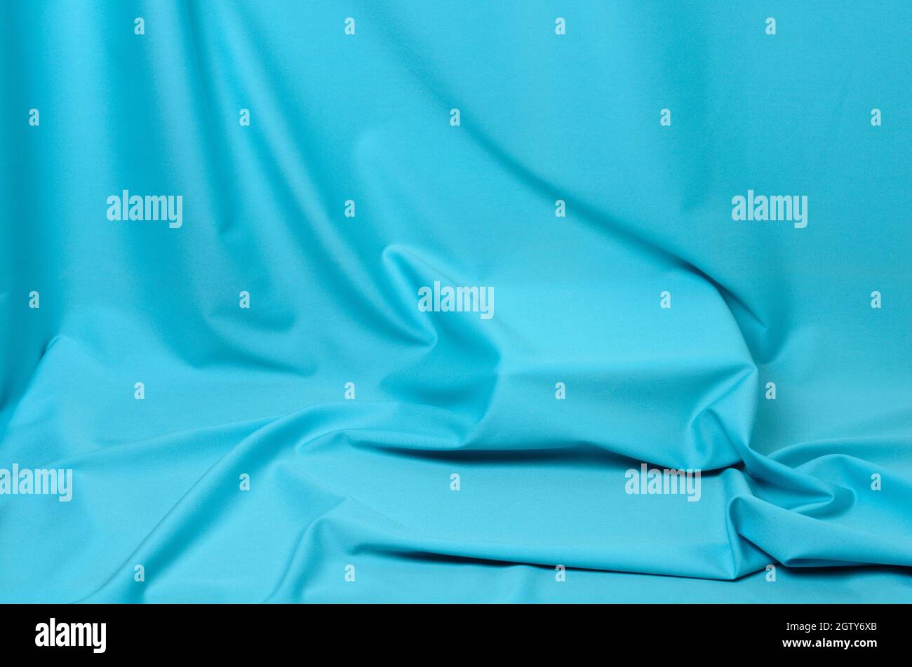 Textured background made of soft blue fabric with elegant pleats ...