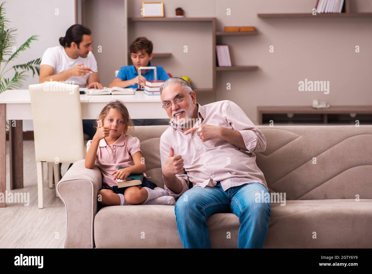 Three generations at home in early development concept Stock Photo - Alamy