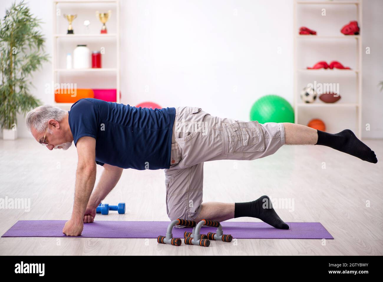 Old man doing sport exercises at home Stock Photo - Alamy