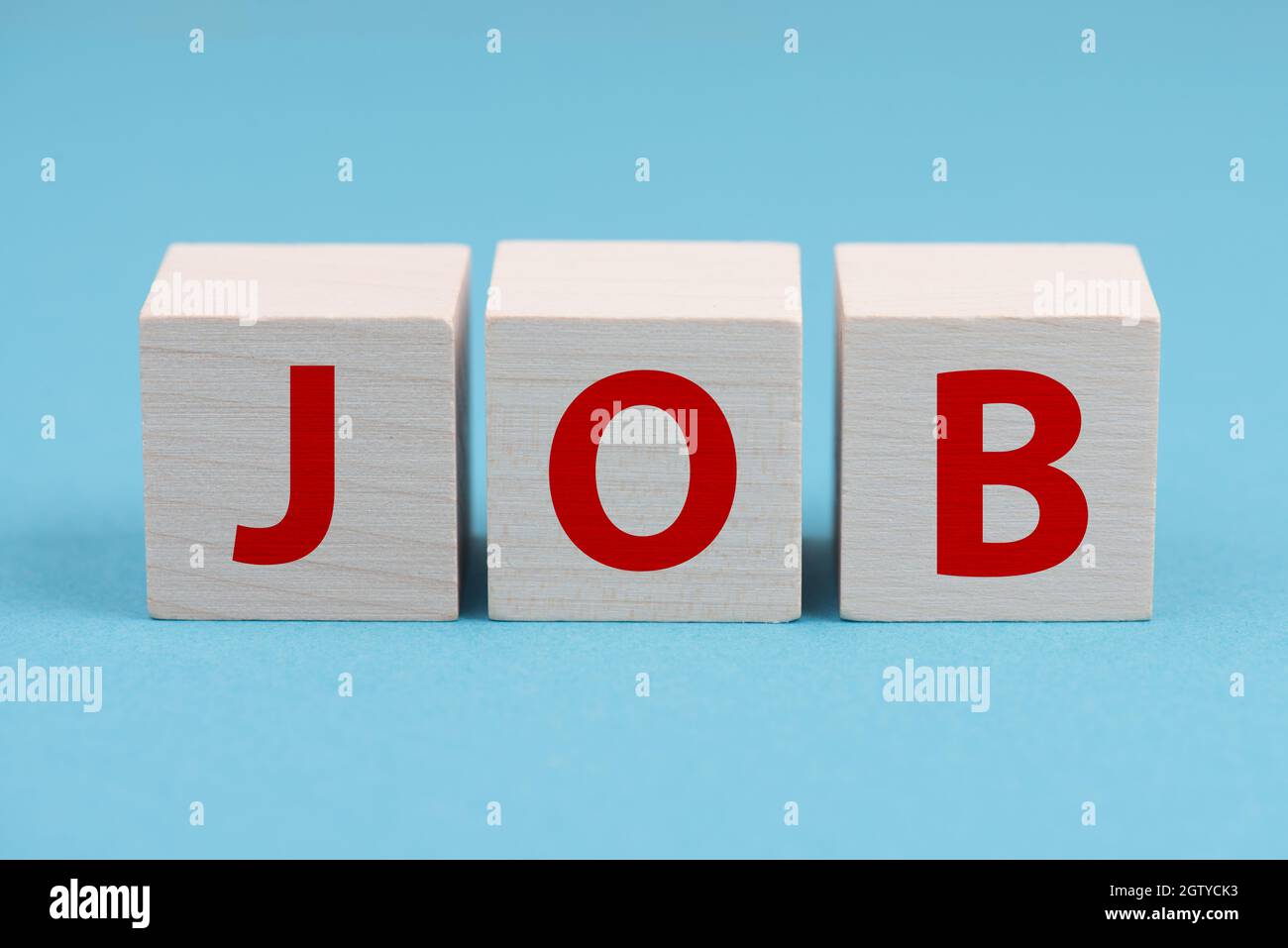 The word job is standing in red letters on wooden cubes, blue ...