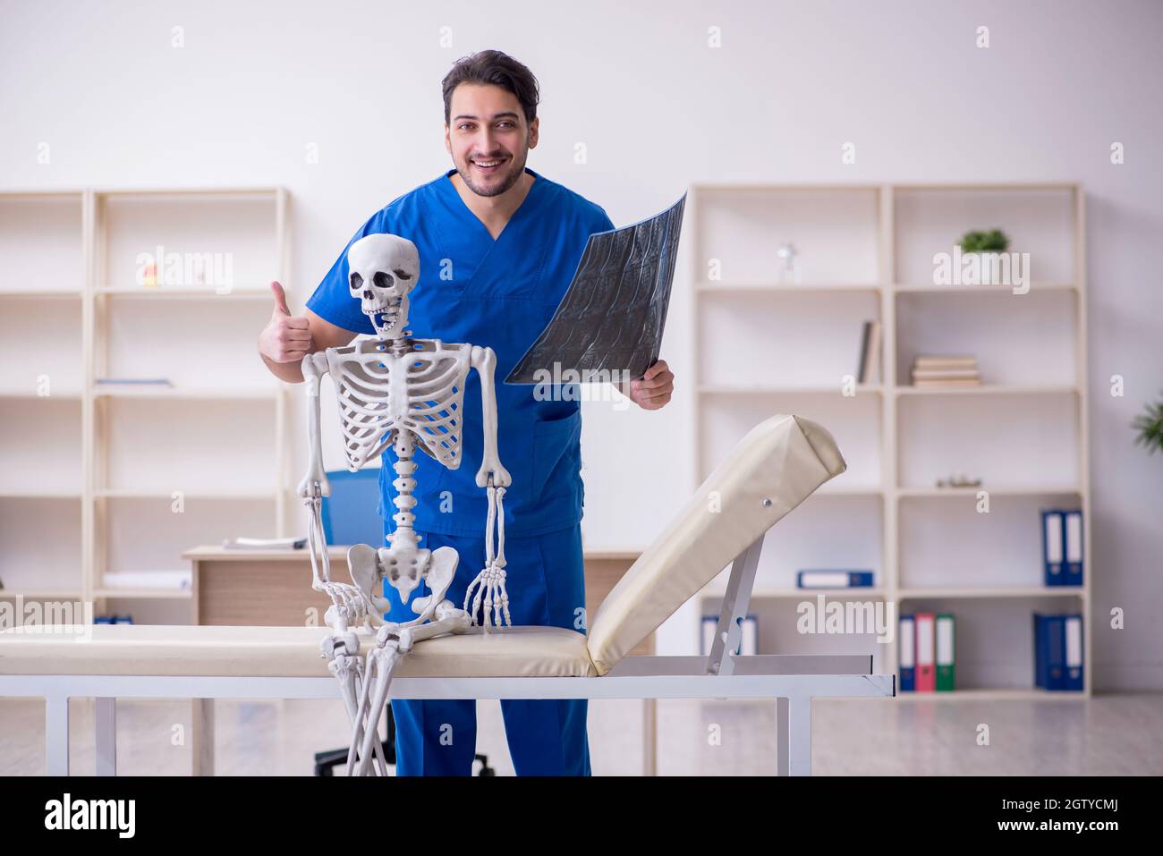 Young doctor radiologist examining skeleton patient Stock Photo - Alamy