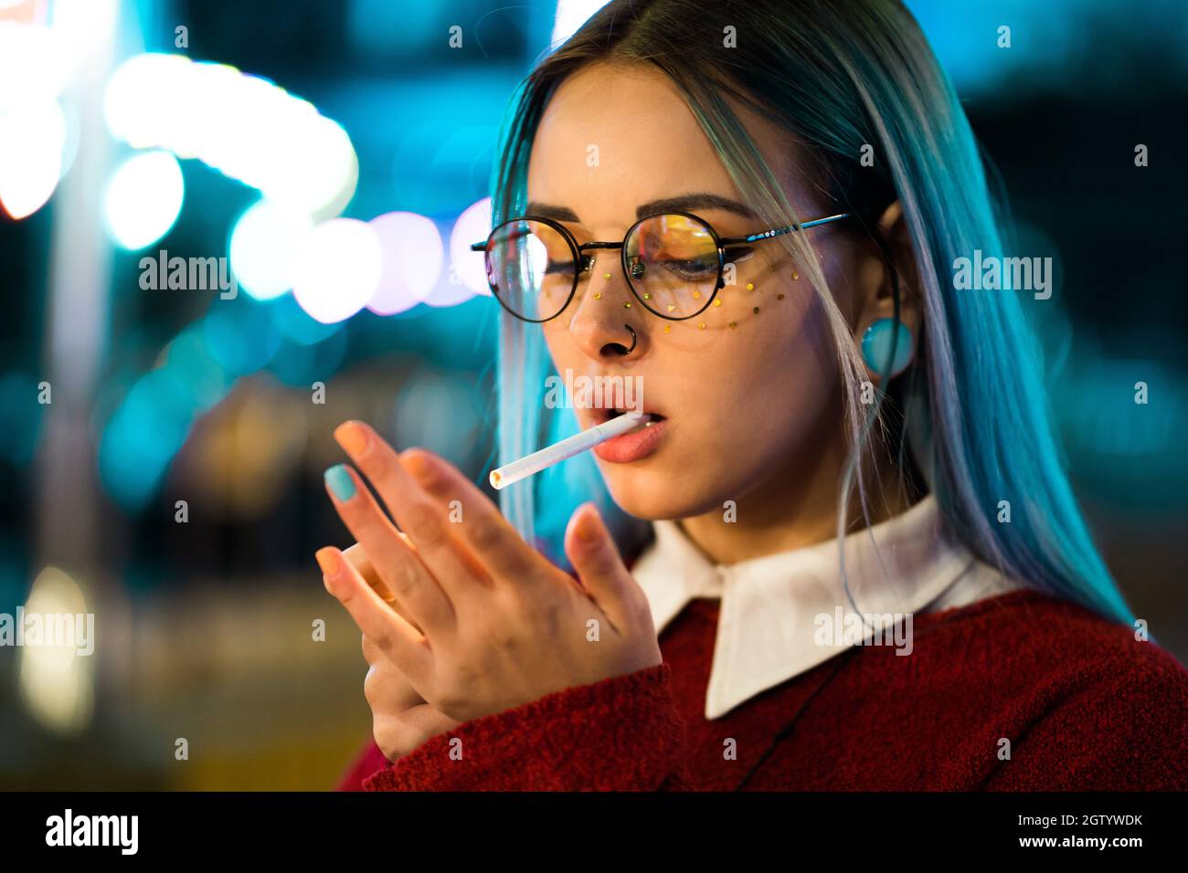 Beautiful young woman lighting cigarette hi-res stock photography and ...