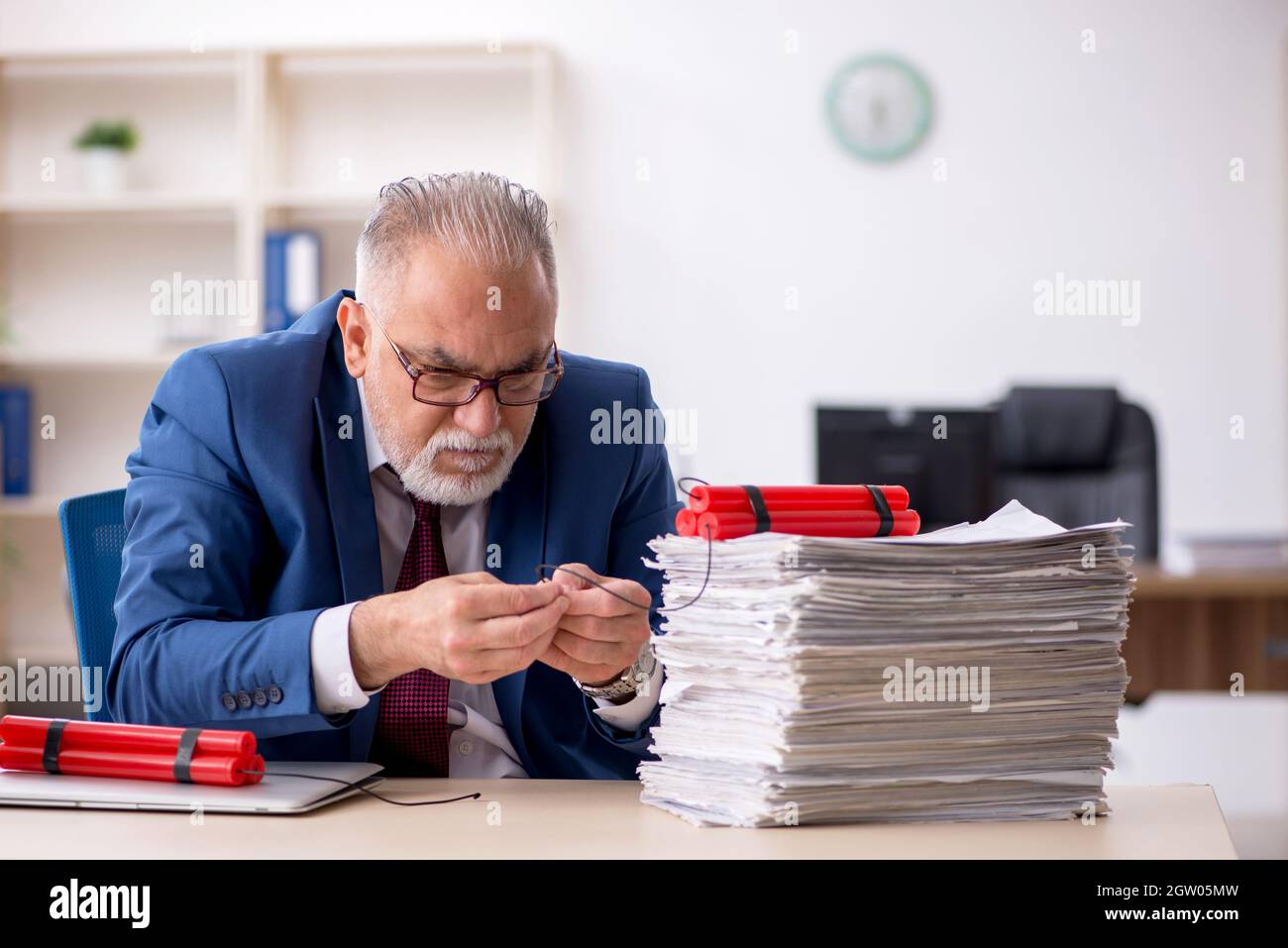 Old employee unhappy with excessive work in the office Stock Photo - Alamy