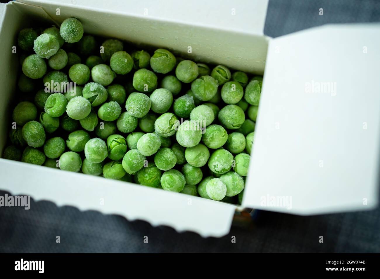 Close-up macro shot frozen peas in cardboard carton box Stock Photo - Alamy