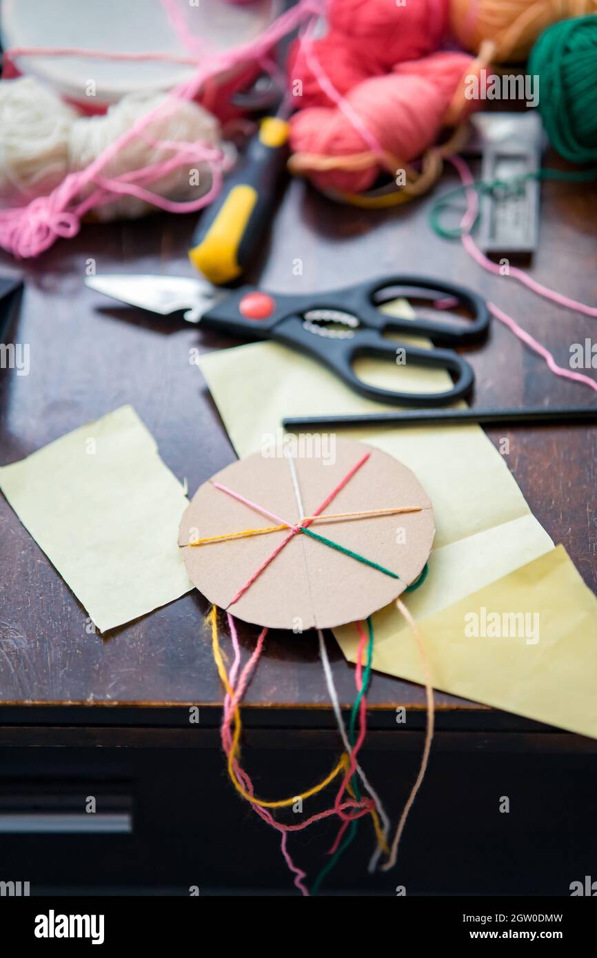 Making A Braided Friendship Bracelet Using A Cardboard And Yarn Stock ...
