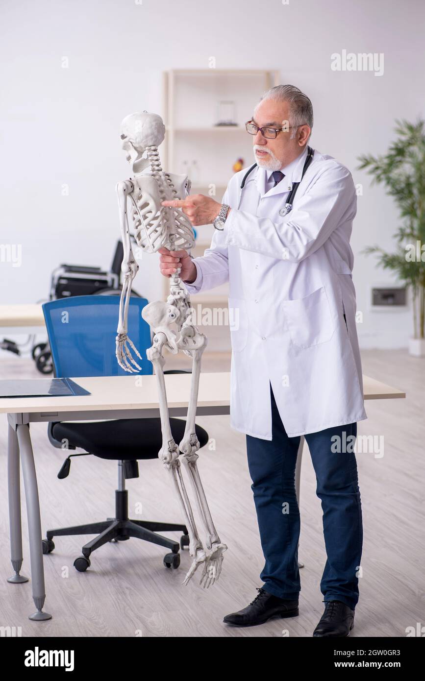 Old doctor demonstrating human skeleton Stock Photo - Alamy