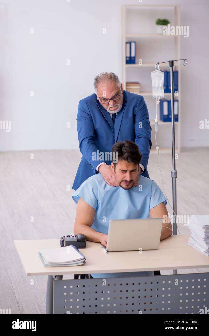 Young employee feeling bad at workplace Stock Photo - Alamy