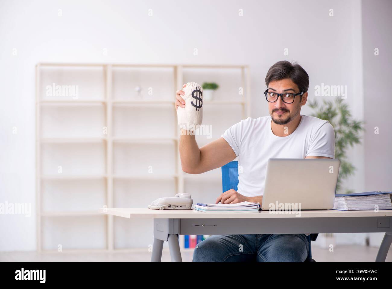 Young employee freelancer in remuneration concept Stock Photo - Alamy