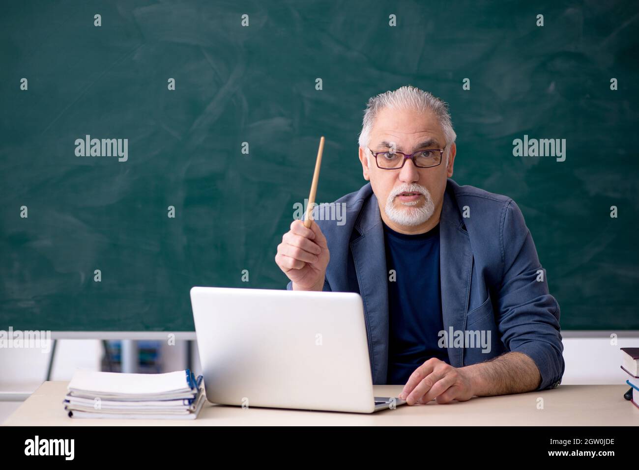Old teacher in the classroom Stock Photo - Alamy