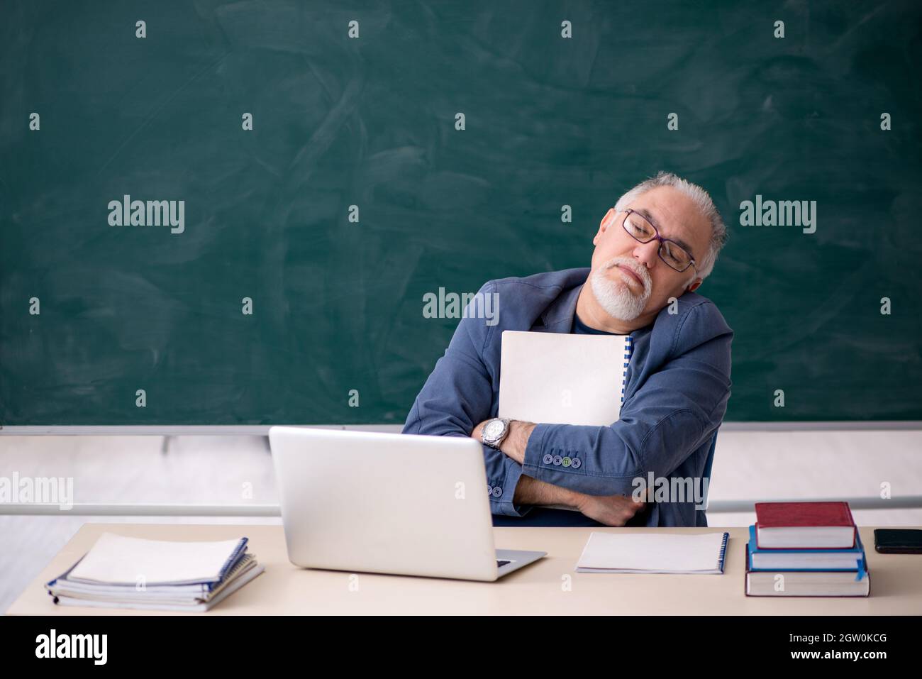 Old teacher in the classroom Stock Photo - Alamy