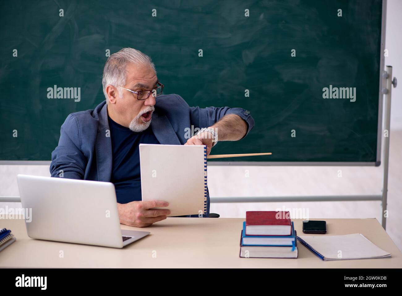Old teacher in the classroom Stock Photo - Alamy