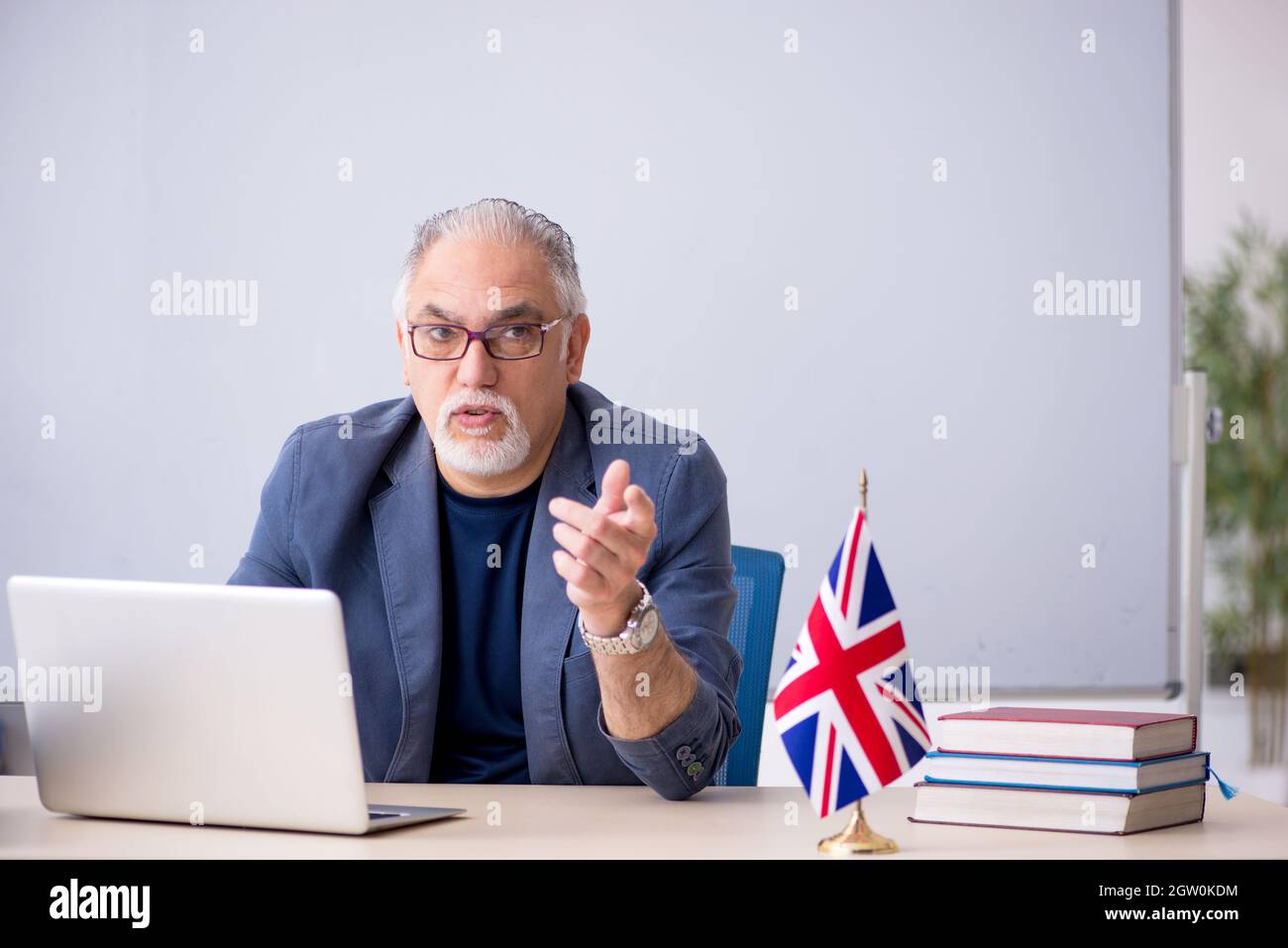 Old english language teacher in the classroom Stock Photo - Alamy