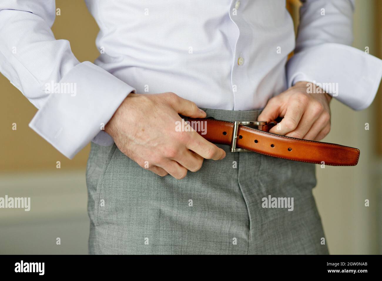 Man adjusting belt hi-res stock photography and images - Alamy