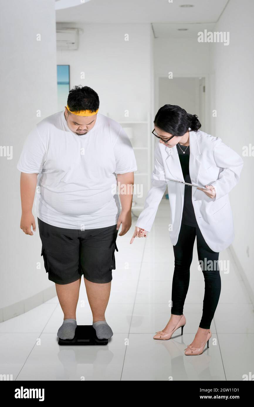 Worried doctor and overweight patient hi-res stock photography and ...