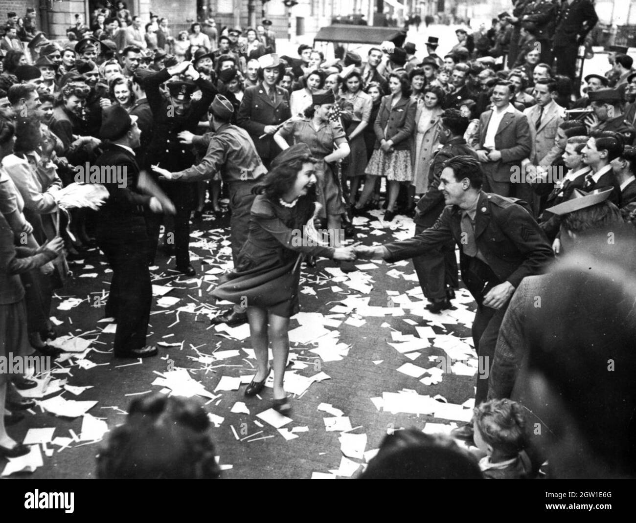 People dancing in the streets on VE Day (Victory in Europe Day), the ...