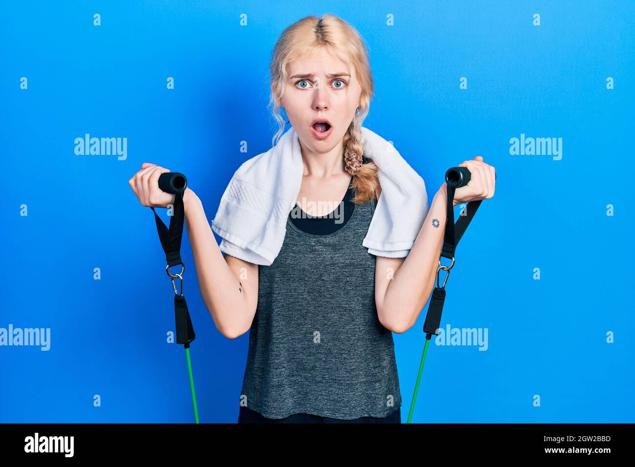 Beautiful caucasian sports woman with blond hair training arm ...