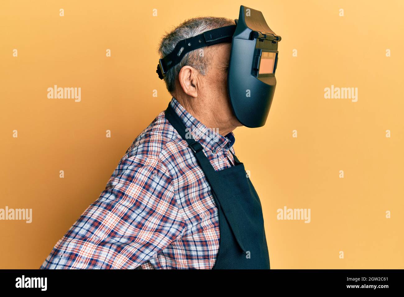 Repair man wearing professional welding mask over head covering face ...