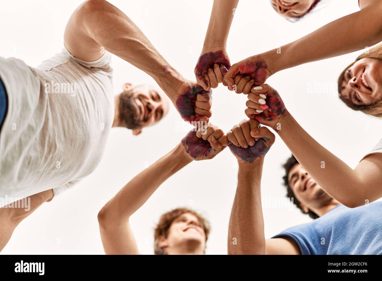 Group of young friends with fists together Stock Photo - Alamy