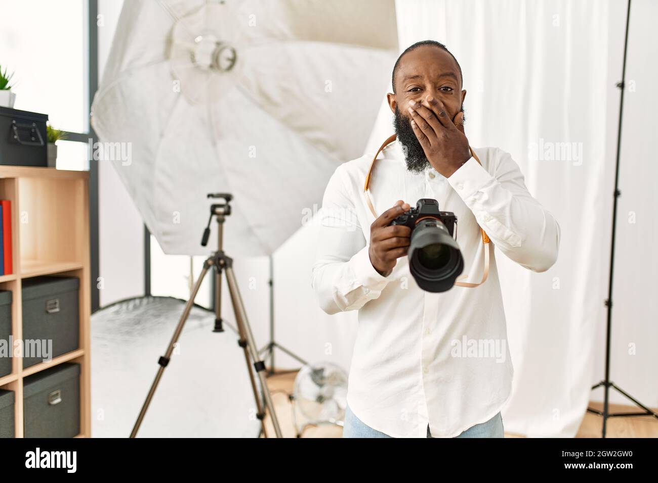 African american photographer man working at photography studio ...