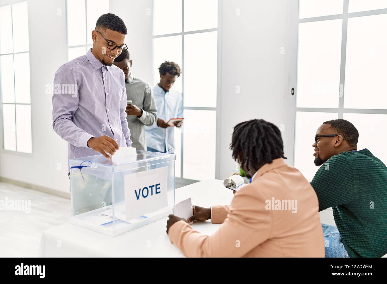 Group of young african american voter people putting vote in ballot ...
