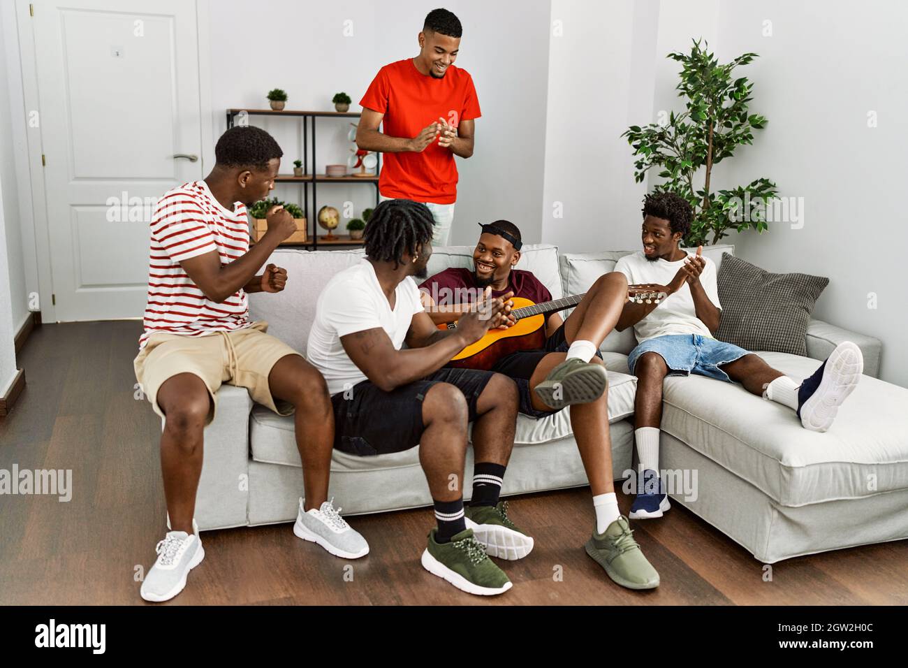 Group of african american people having party playing classical guitar ...