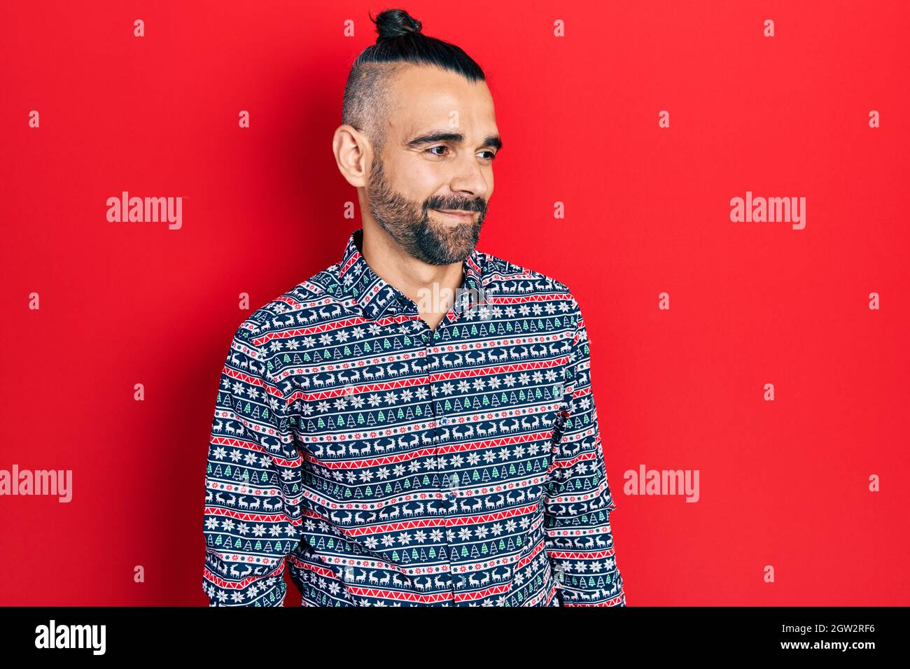Young hispanic man wearing casual clothes looking to side, relax ...