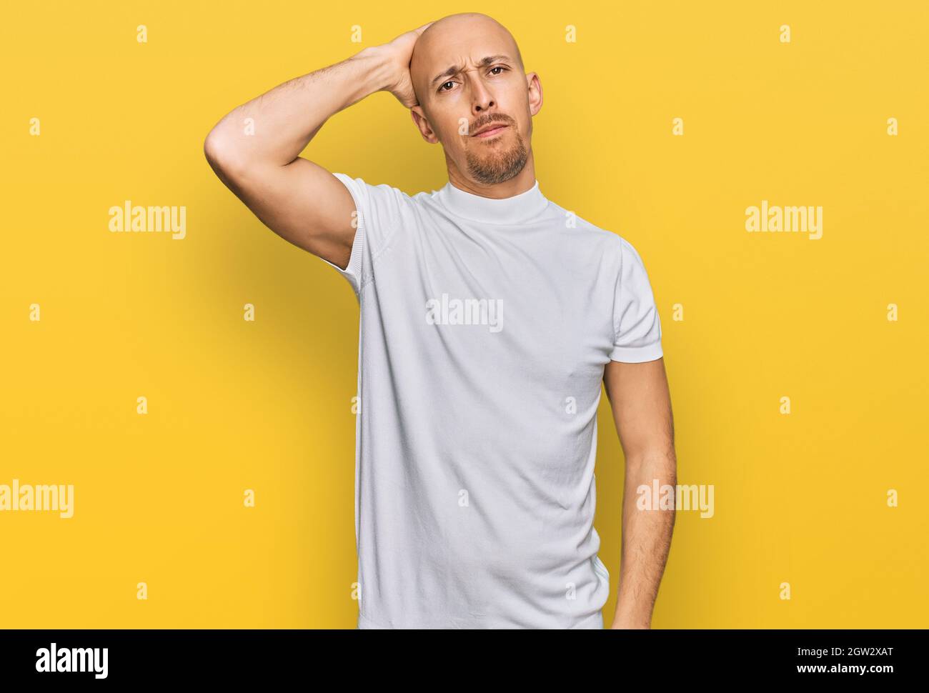 Bald man with beard wearing casual white t shirt confuse and wonder ...