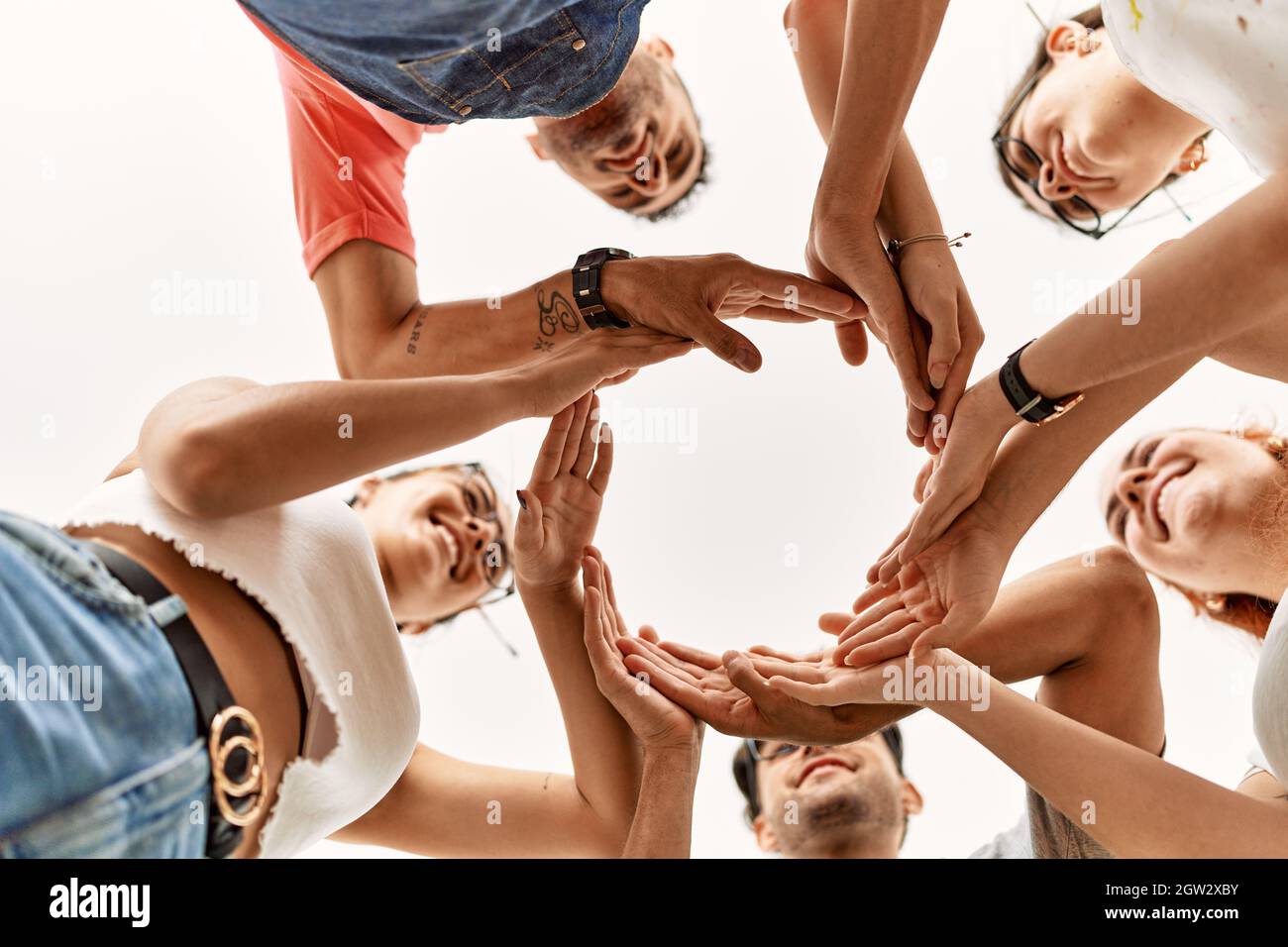 Group of young friends doing circle symbol with hands together Stock ...