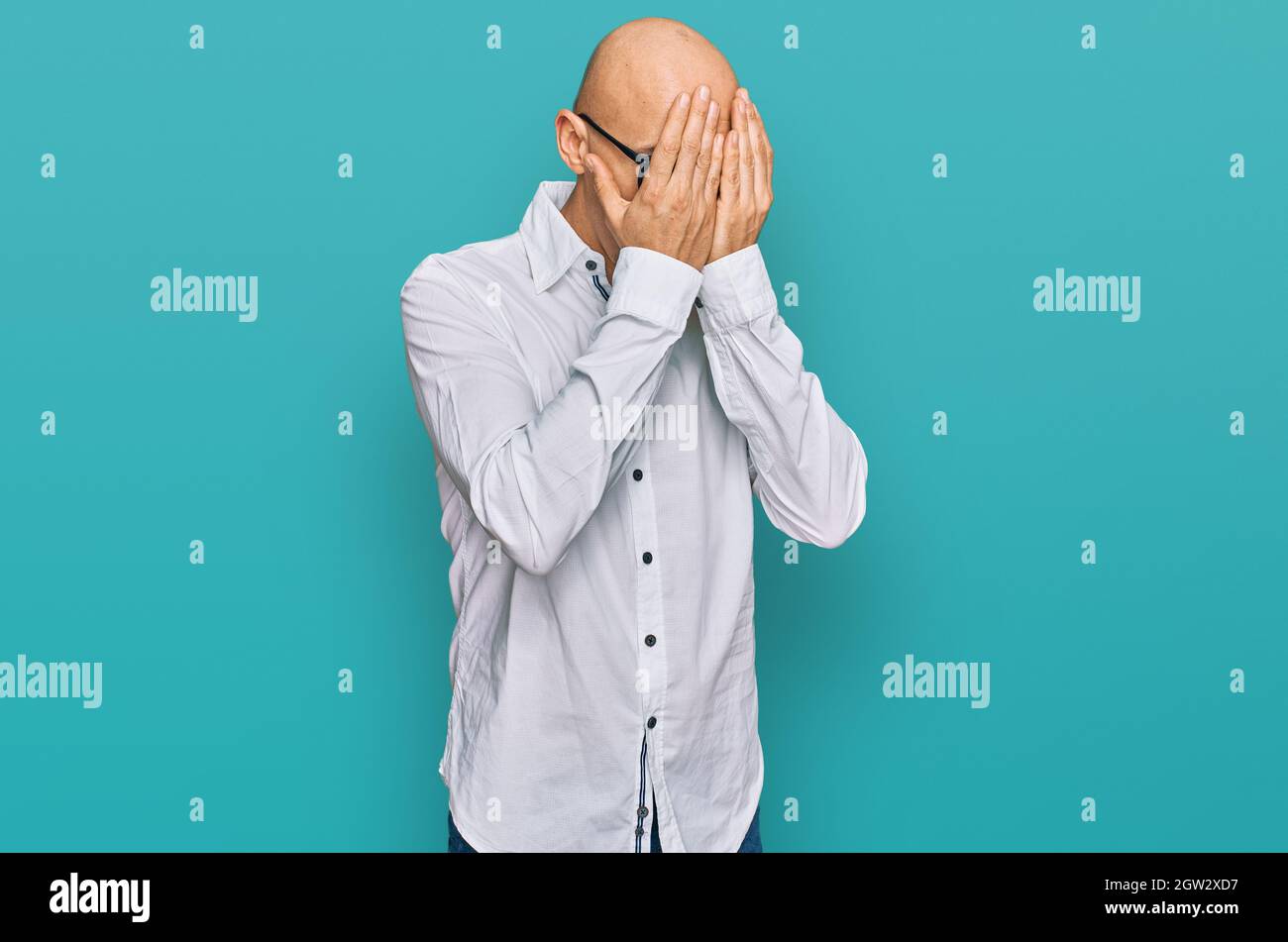 Bald man with beard wearing business shirt and glasses with sad ...