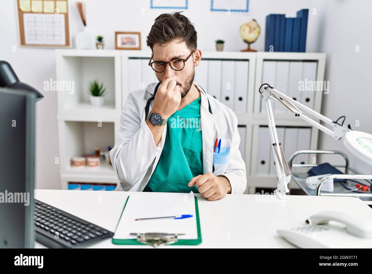 Young man with beard wearing doctor uniform and stethoscope at the ...